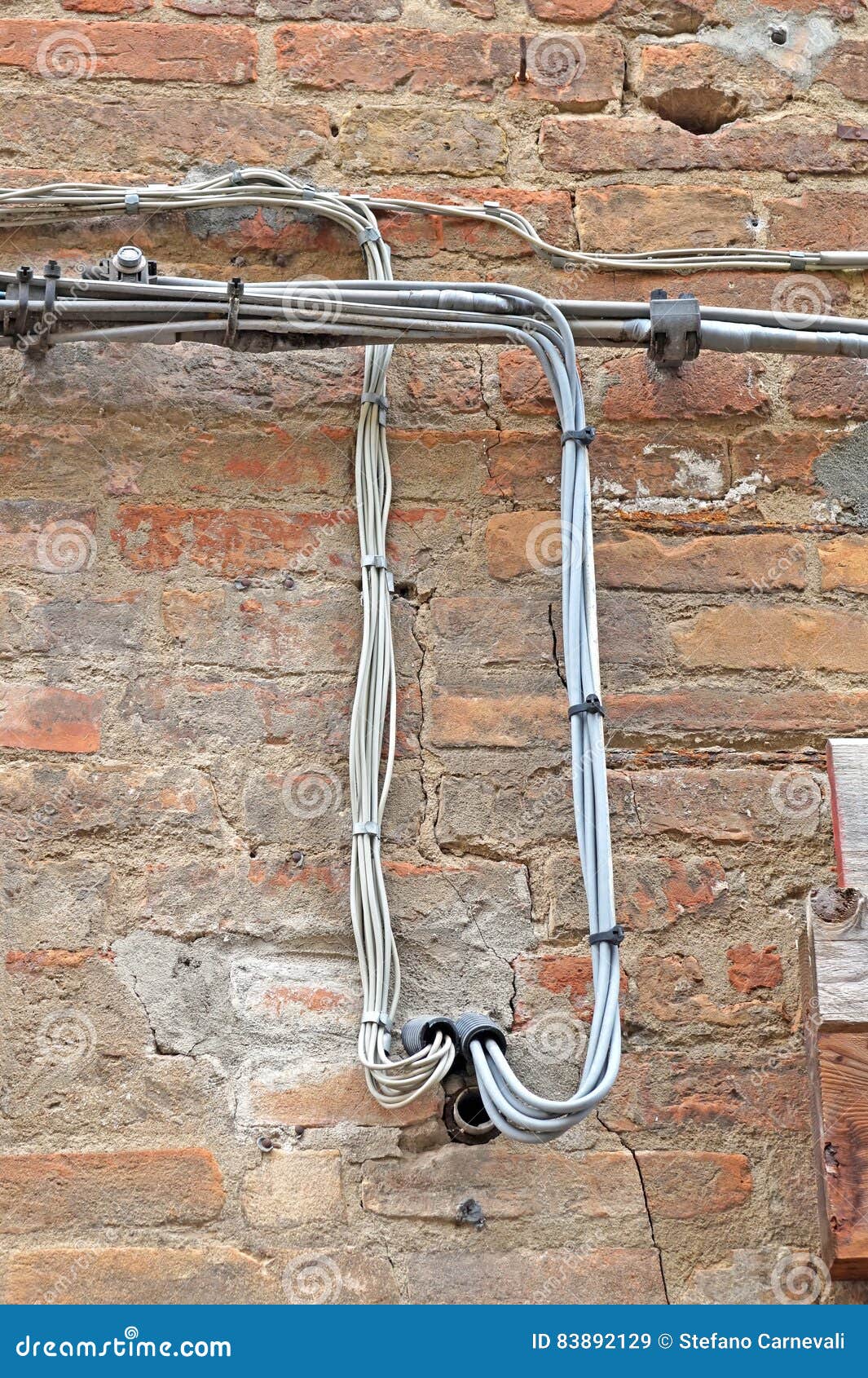 Electric And Telephone Cables And Wires On A Pole In The Streets Of The ...