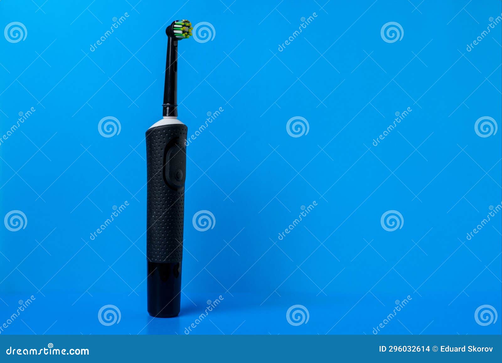 Electric Toothbrush. a Black Toothbrush on a Blue Background Stock ...