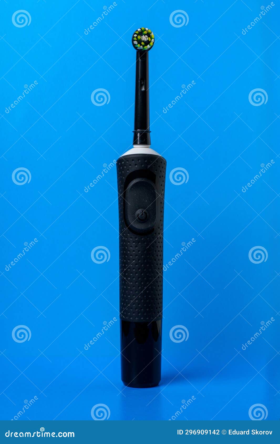 Electric Toothbrush. a Black Toothbrush on a Blue Background, Vertical ...