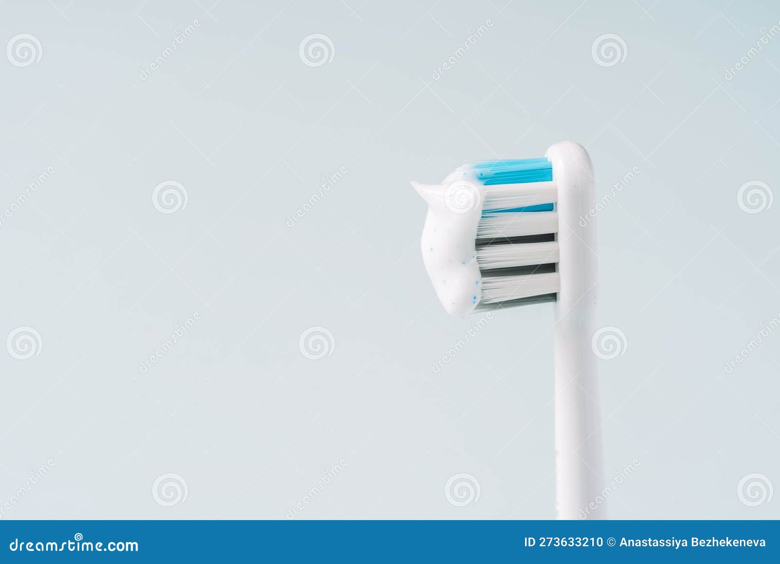 Electric Toothbrush Head with Toothpaste Against Blue Background Stock ...
