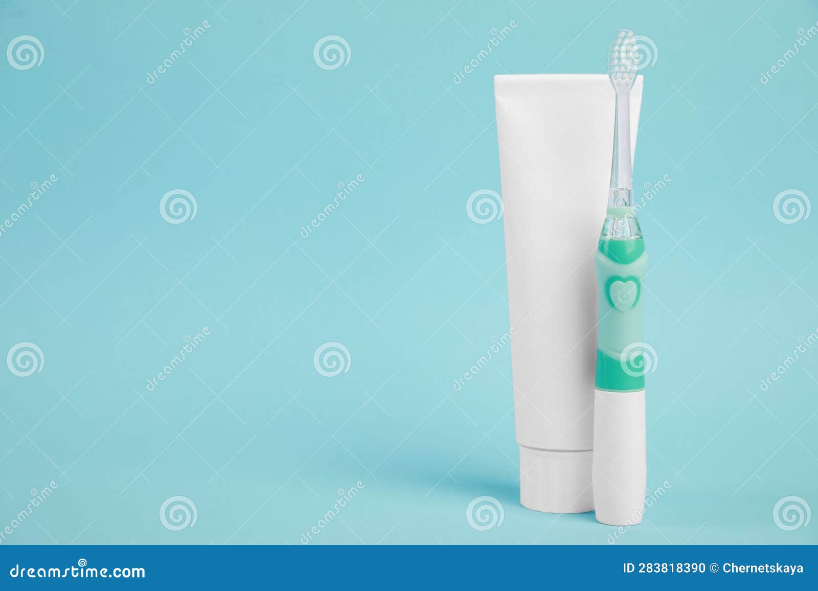 Electric Toothbrush and Toothpaste on Light Blue Background, Space for ...
