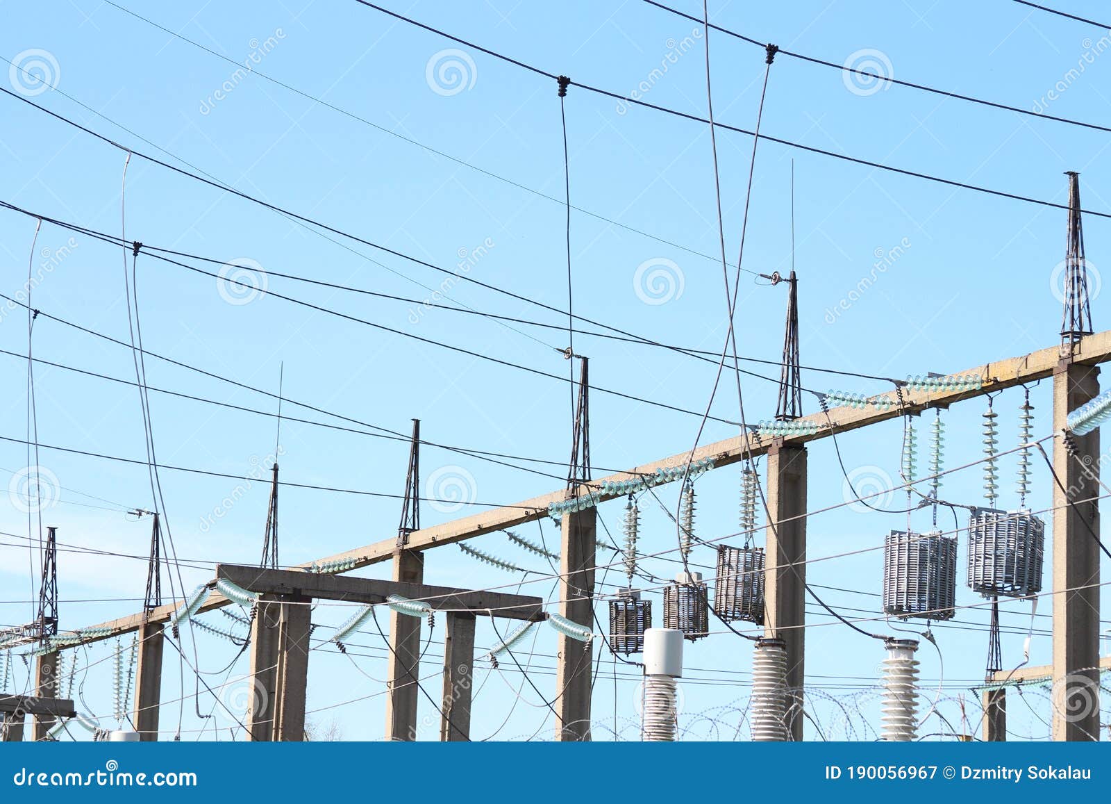 Electric Transformers are Suspended on Concrete Poles Against the Sky ...