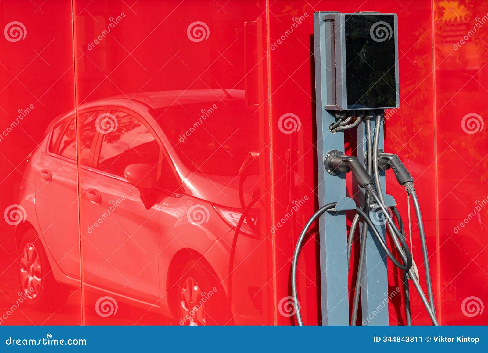 Electric Vehicle Charging Station with a Red Backdrop during Daylight ...