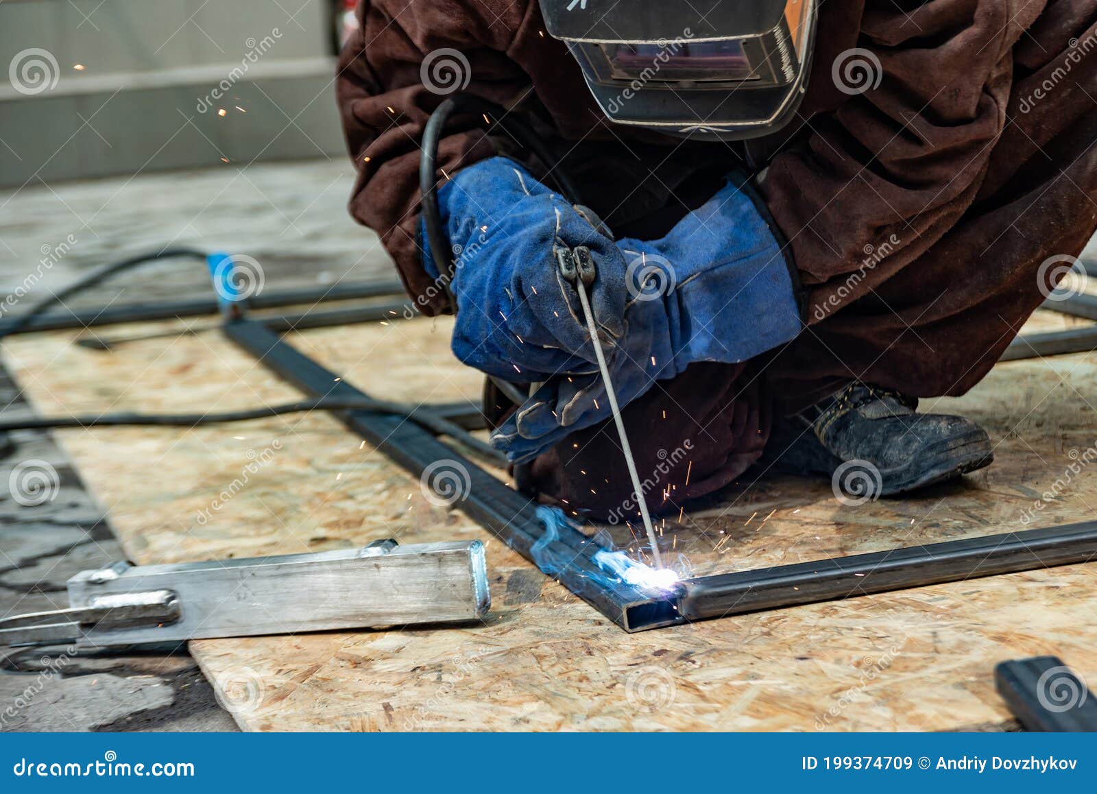 A Welder Assembles A Frame From A Metal Structure By Connecting It With ...