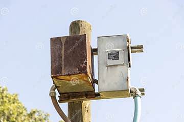 Electrical Boxes Mounted To Pole Stock Image - Image of utility, brown ...