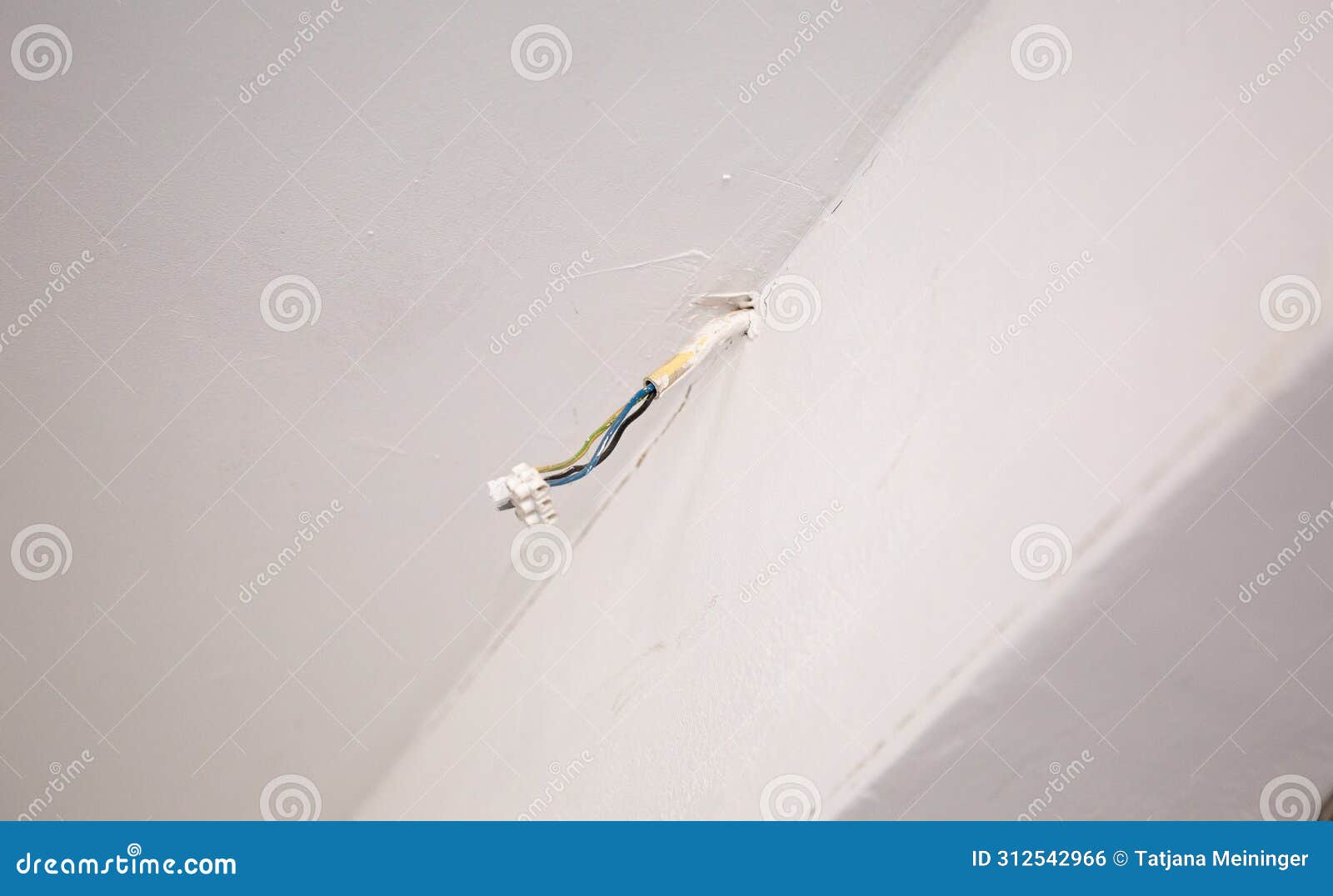 An Electrical Cable Hanging Out of a White Wall Stock Photo - Image of ...