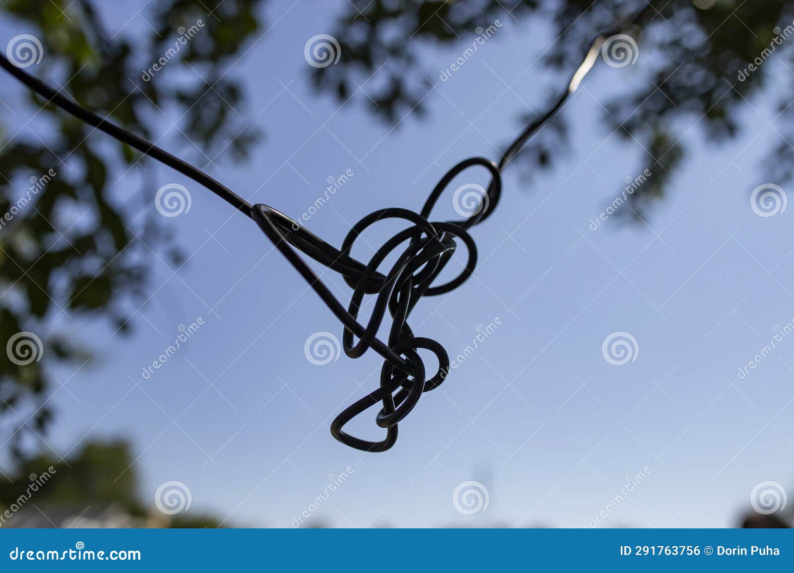 Electrical Cable Knot on Blue Sky Background with Defocused Tree Stock ...
