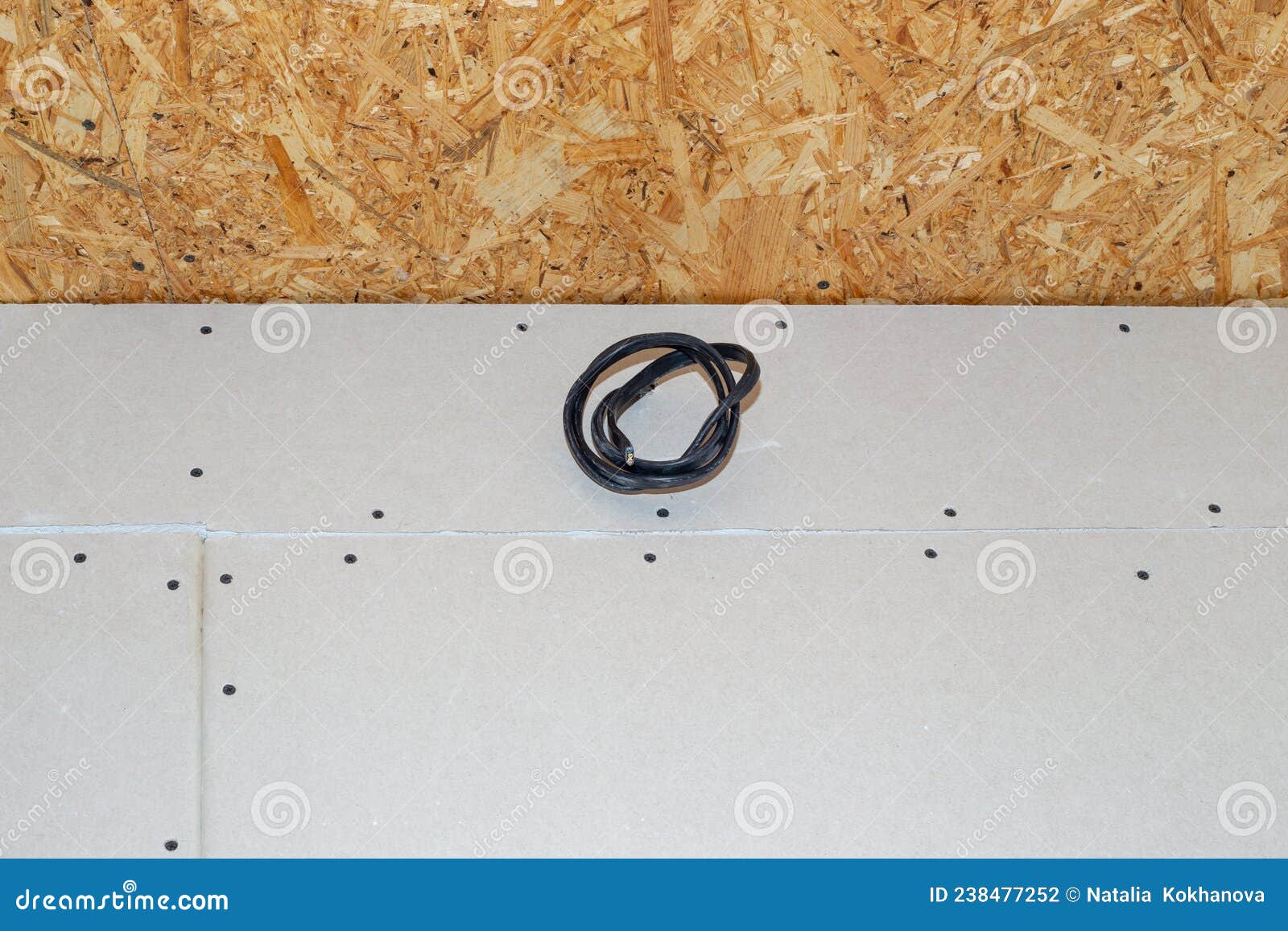 An Electrical Cable Protruding from the Plasterboard Wall for the ...