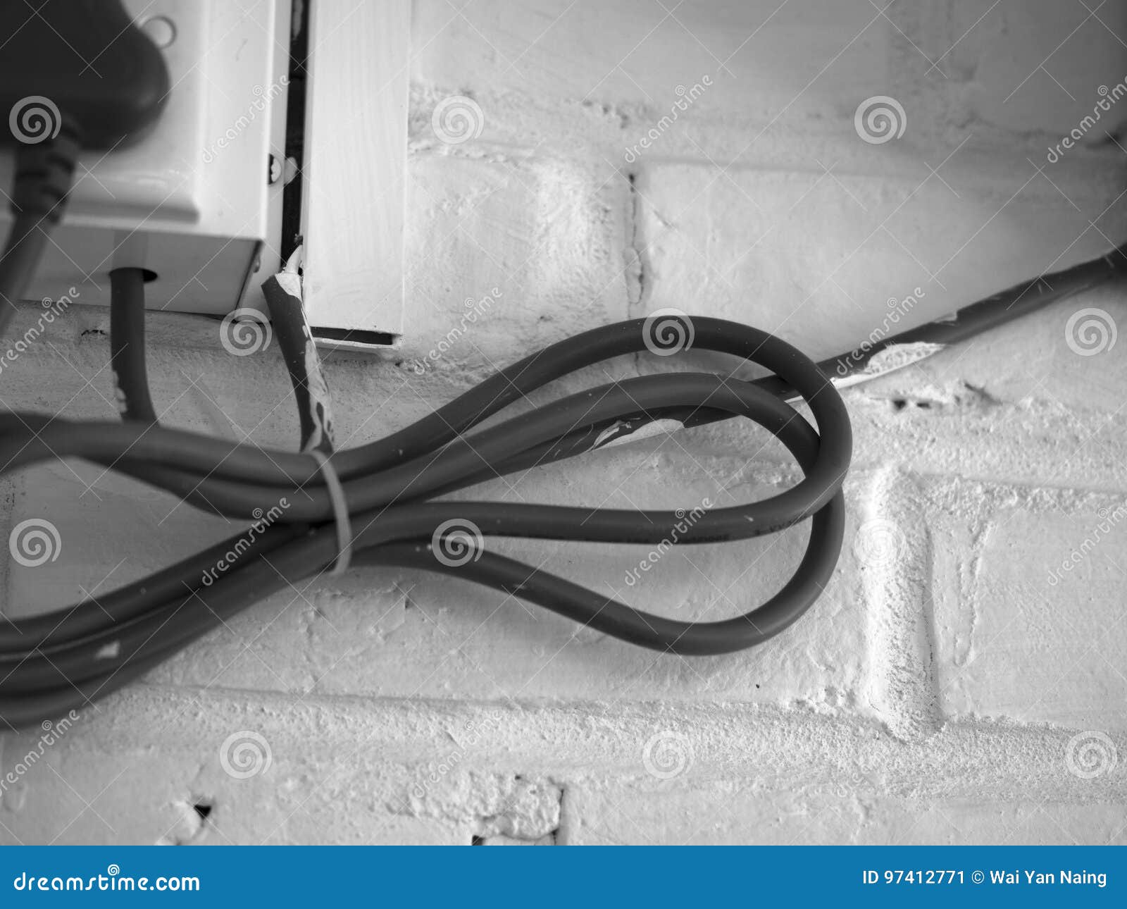 ELECTRICAL CABLE on WHITE BRICK WALL Stock Image - Image of tidy ...