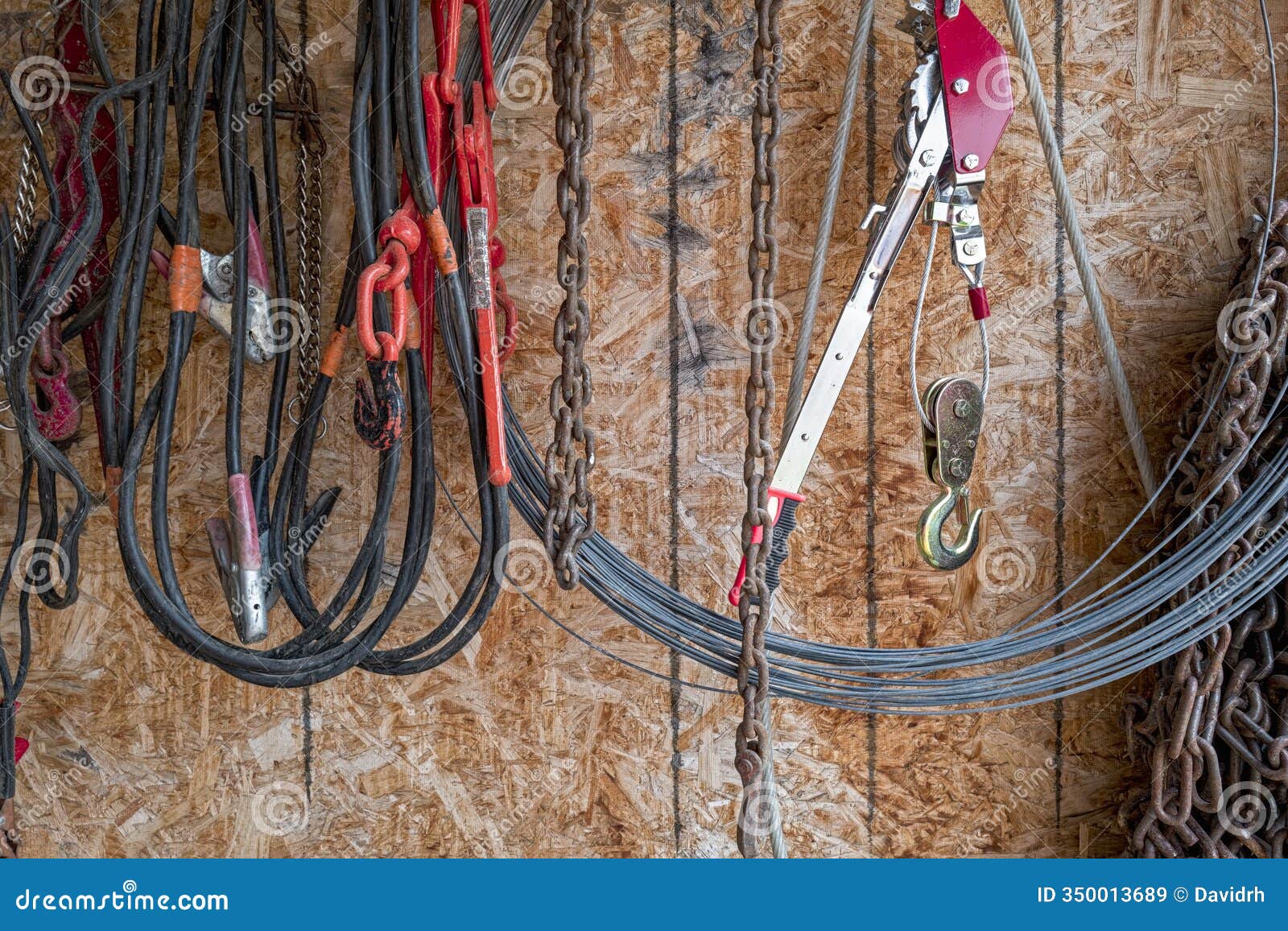 Electrical Cables, Chains, and a Metal Hook Hanging on a Wall in a Barn ...