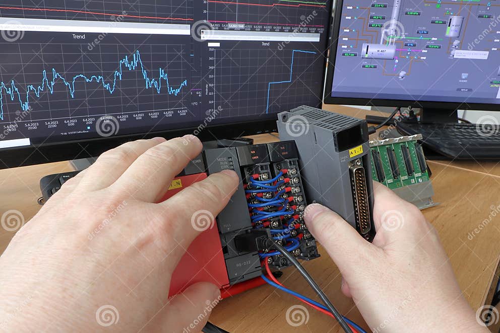 An Electrical Engineer Adds a New IO Card To a Modular PLC Automaton. Stock Image - Image of ...