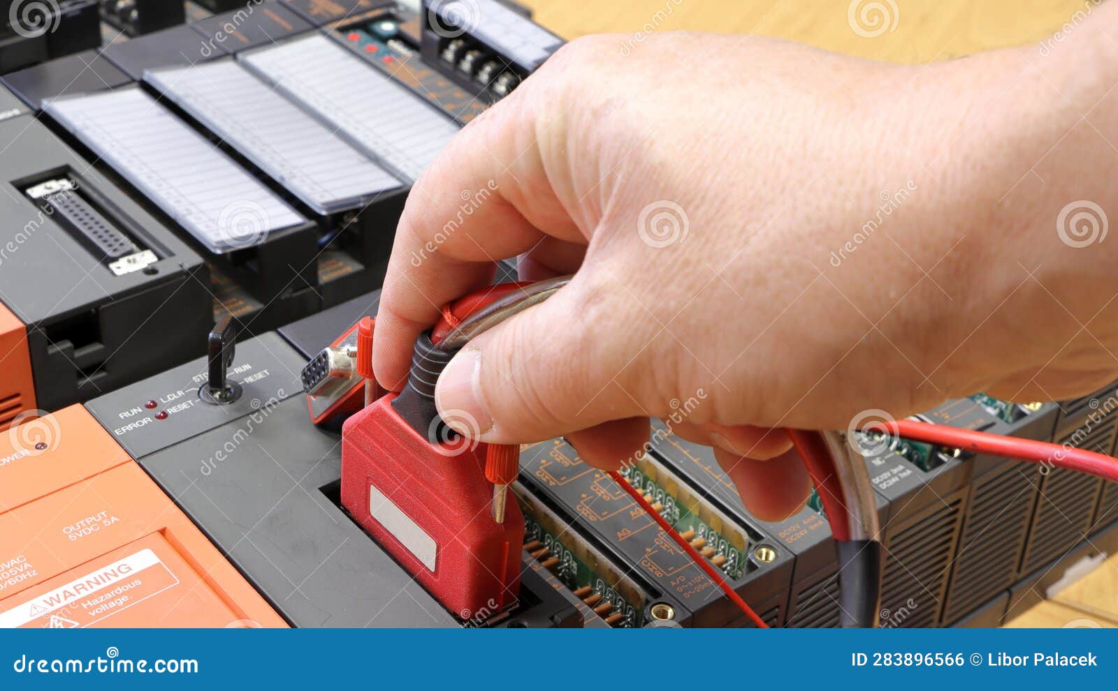 The Electrical Engineer Connects the Communication Cable To the PLC ...