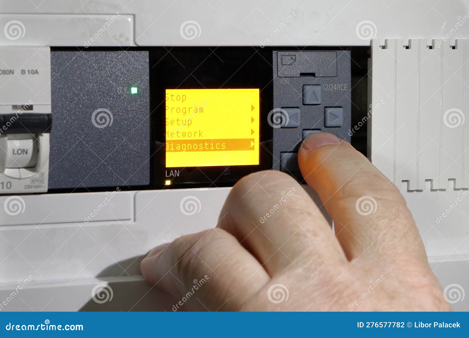 An Electrical Engineer Diagnoses a Programmable Relay. Stock Photo ...