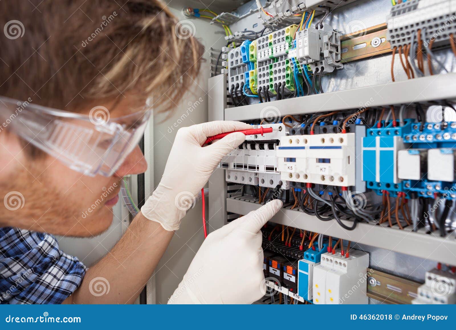 Electrical Engineer Examining Fusebox with Multimeter Probe Stock Photo ...