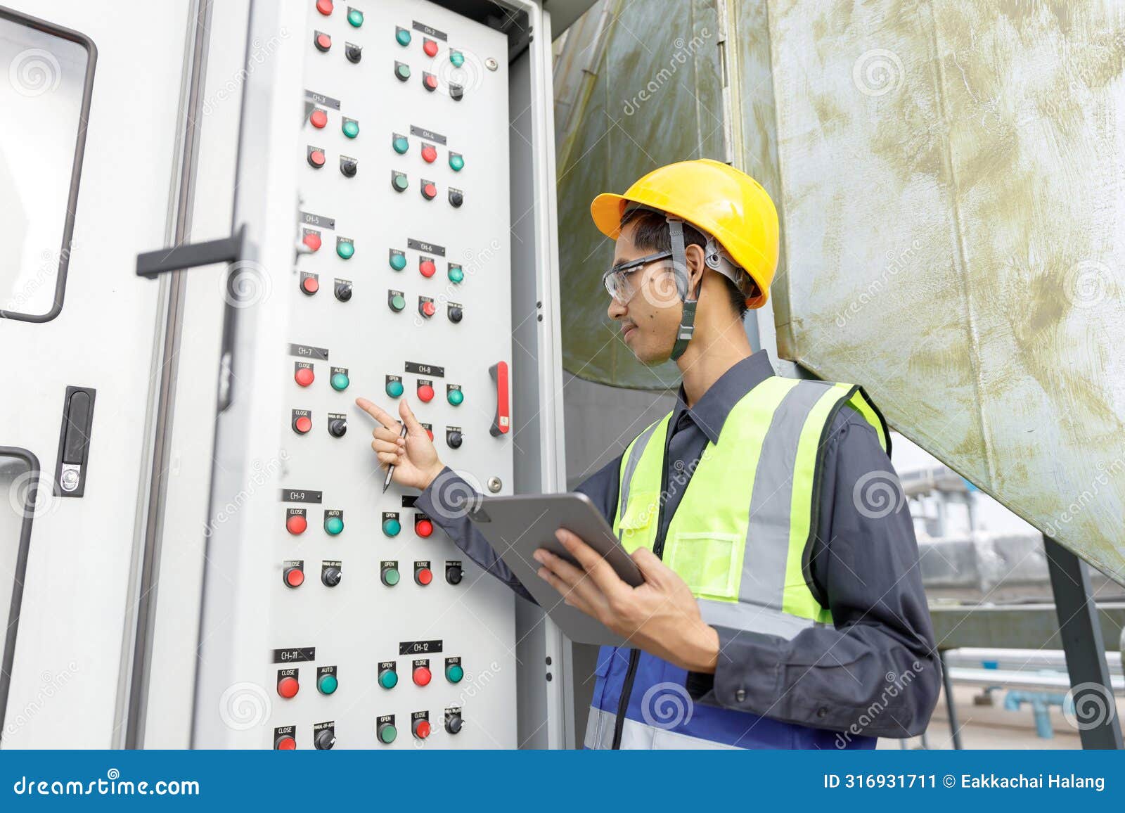 Electrical Engineer Man Using Tablet Checks Switchboard Main ...