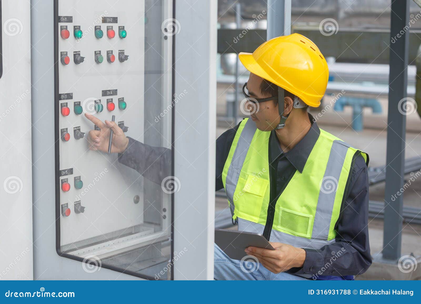 Electrical Engineer Man Using Tablet Checks Switchboard Main ...