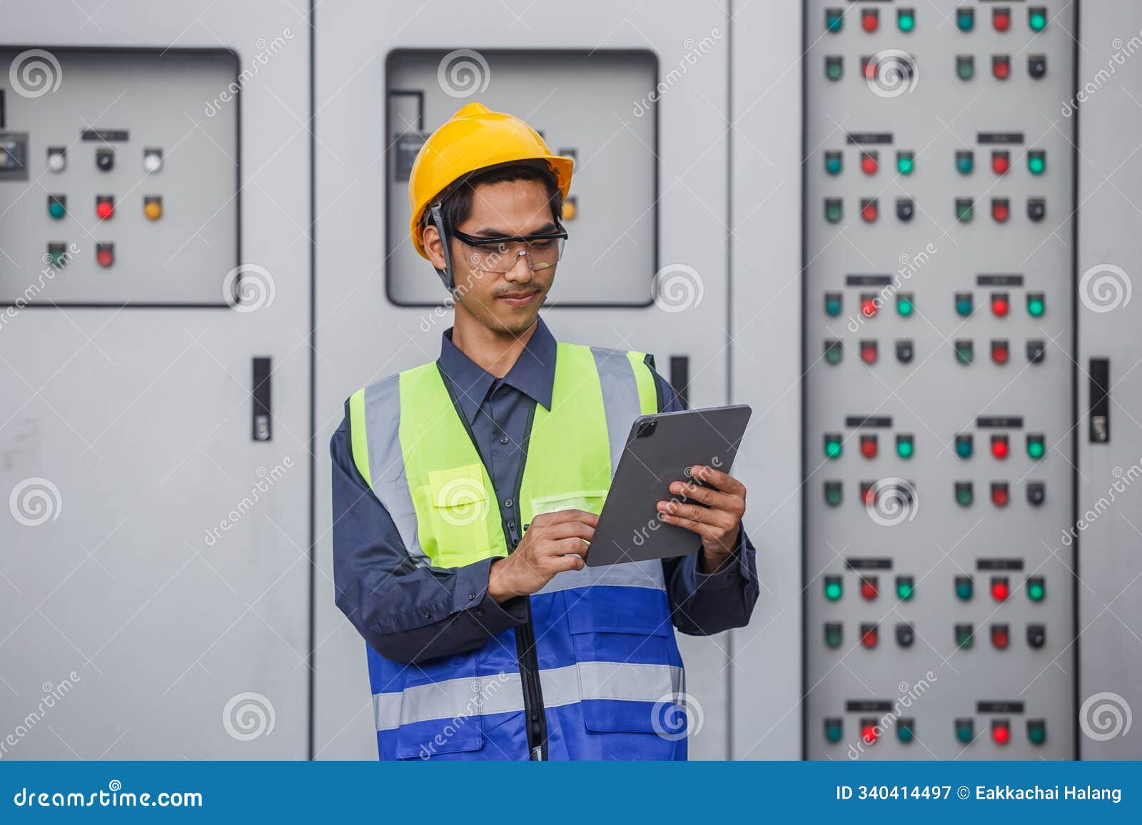 Electrical Engineer Man Using Tablet Checks Switchboard Main ...