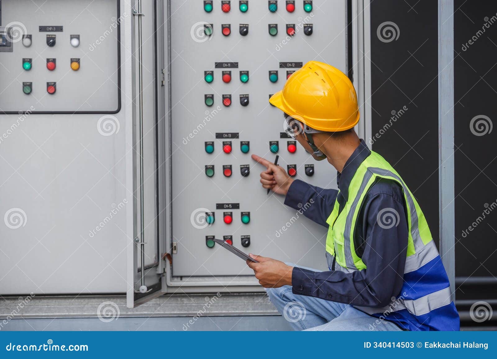 Electrical Engineer Man Using Tablet Checks Switchboard Main ...