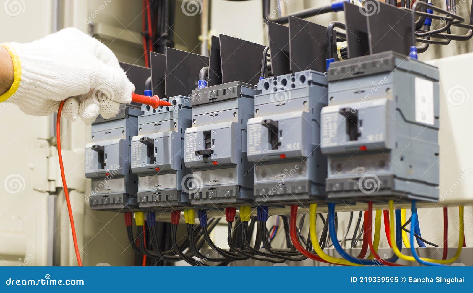 Electrical Engineer Tests the Operation of the Electric Control Cabinet ...
