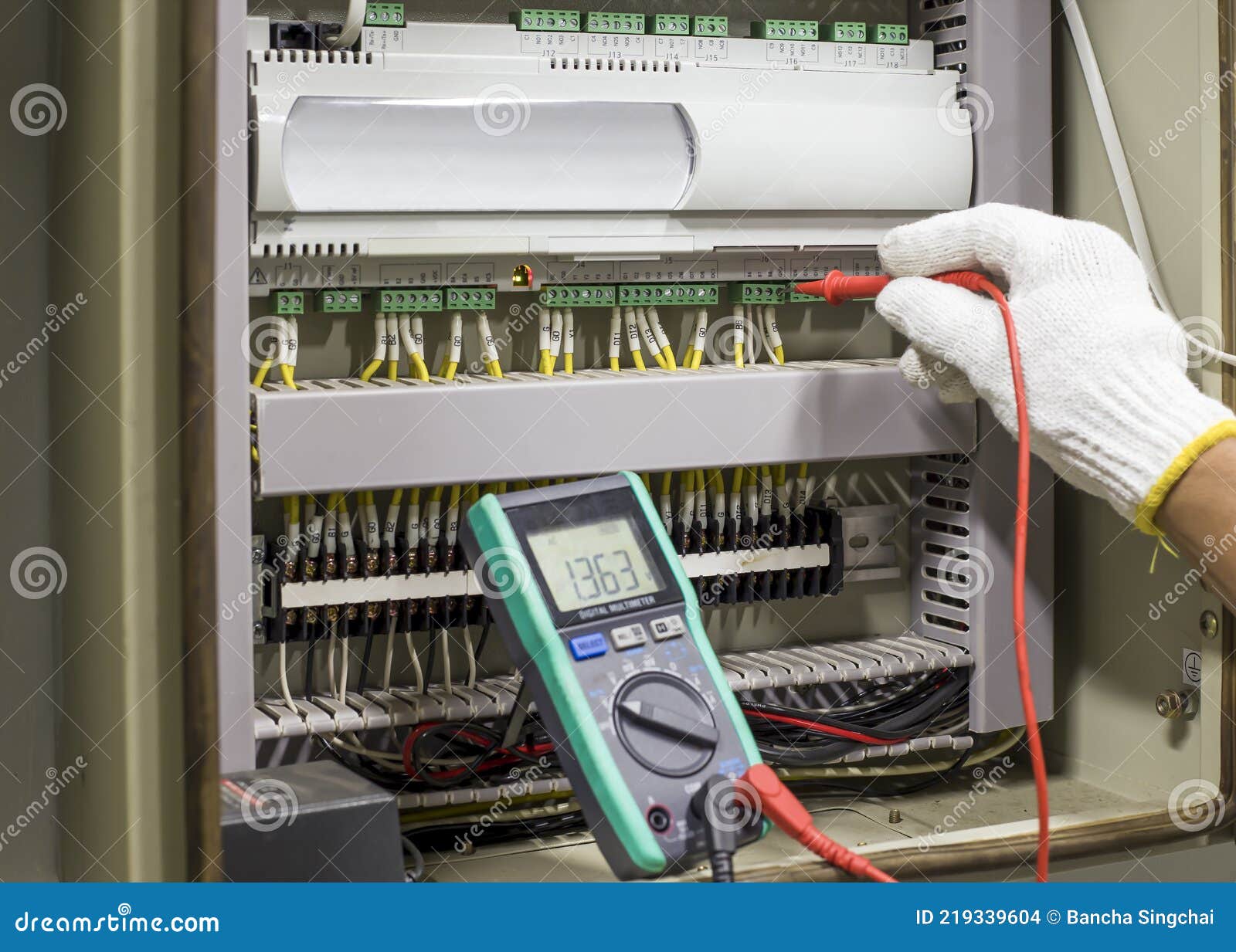 Electrical Engineer Tests the Operation of the Electric Control Cabinet ...