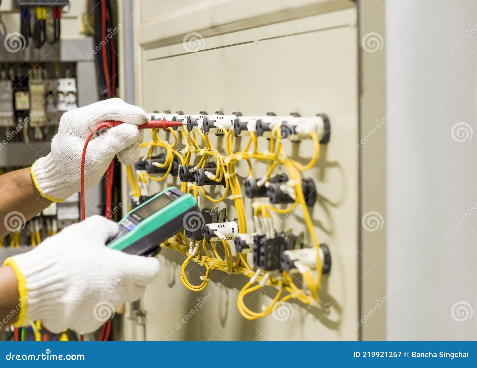 Electrical Engineer Tests the Operation of the Electric Control Cabinet ...