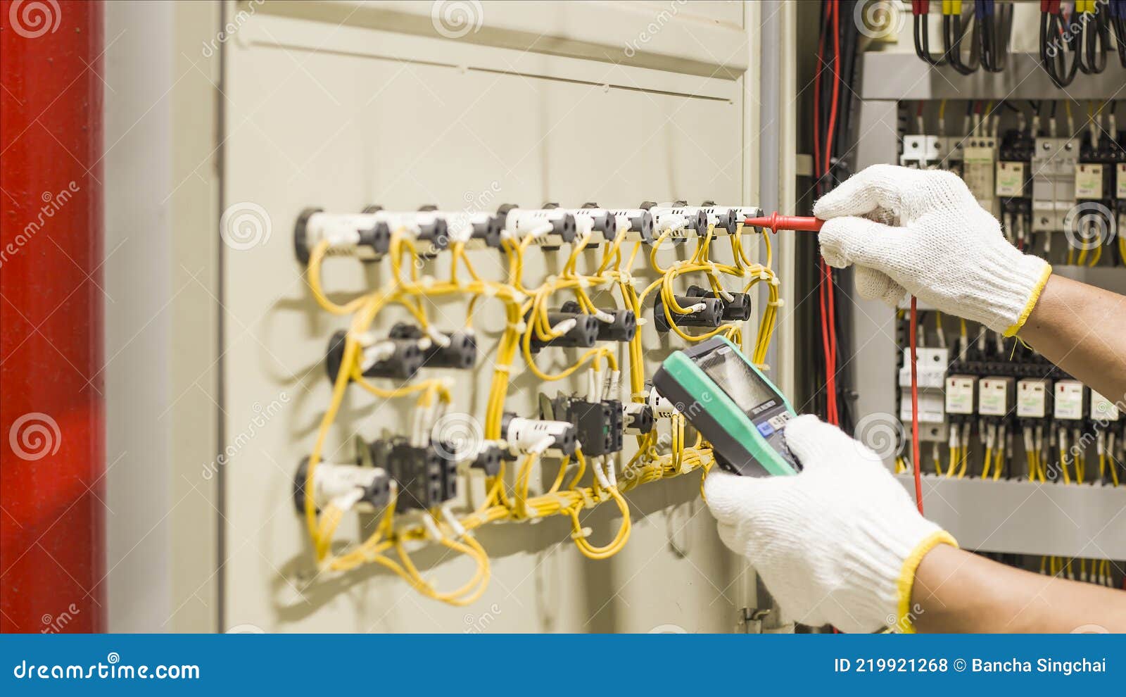 Electrical Engineer Tests the Operation of the Electric Control Cabinet ...