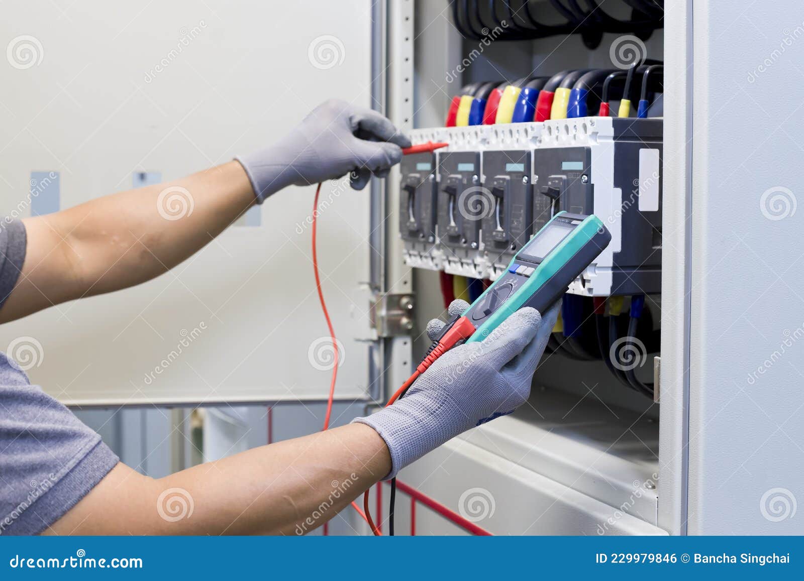 Electrical Engineer Tests the Operation of the Electric Control Cabinet ...