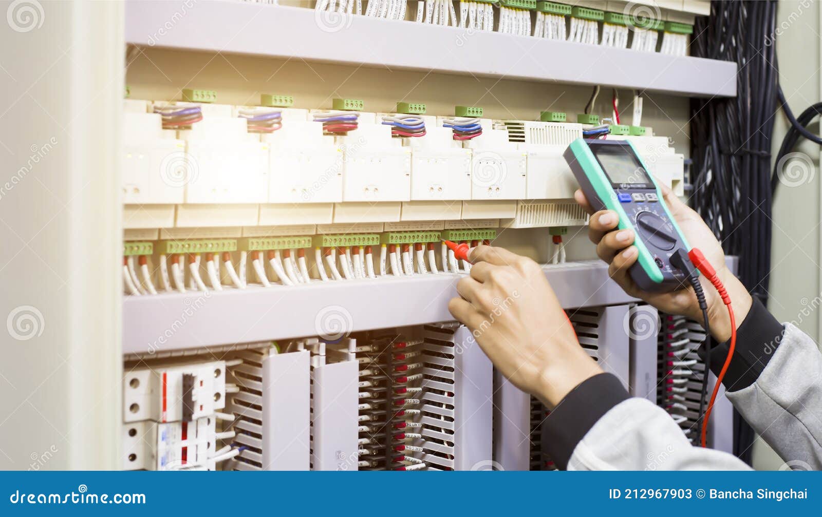 Electrical Engineer Tests the Operation of the Electric Control Cabinet ...