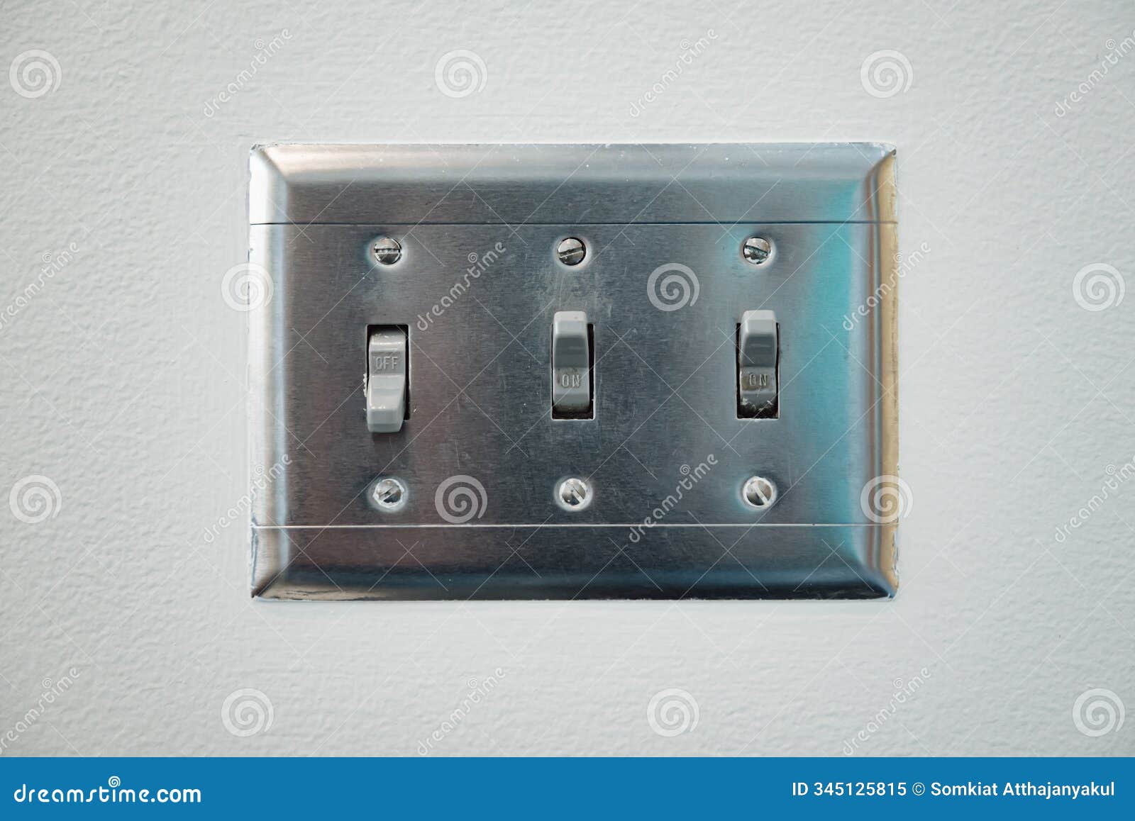 The Electrical Light Switches is Mounted on the White Wall Inside a ...