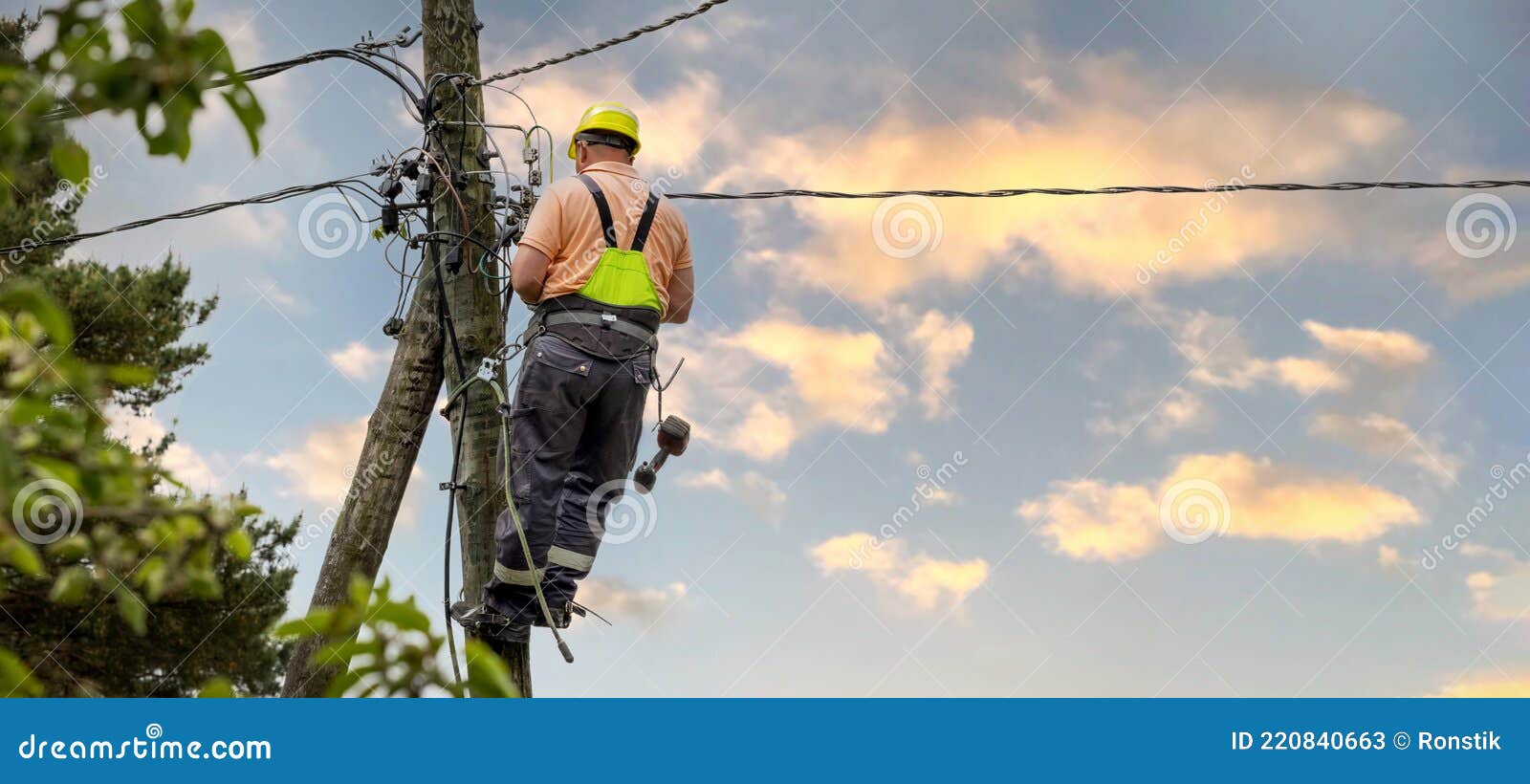 Electrical Lineman Connecting Wires High On Electric Pole. Powerline ...