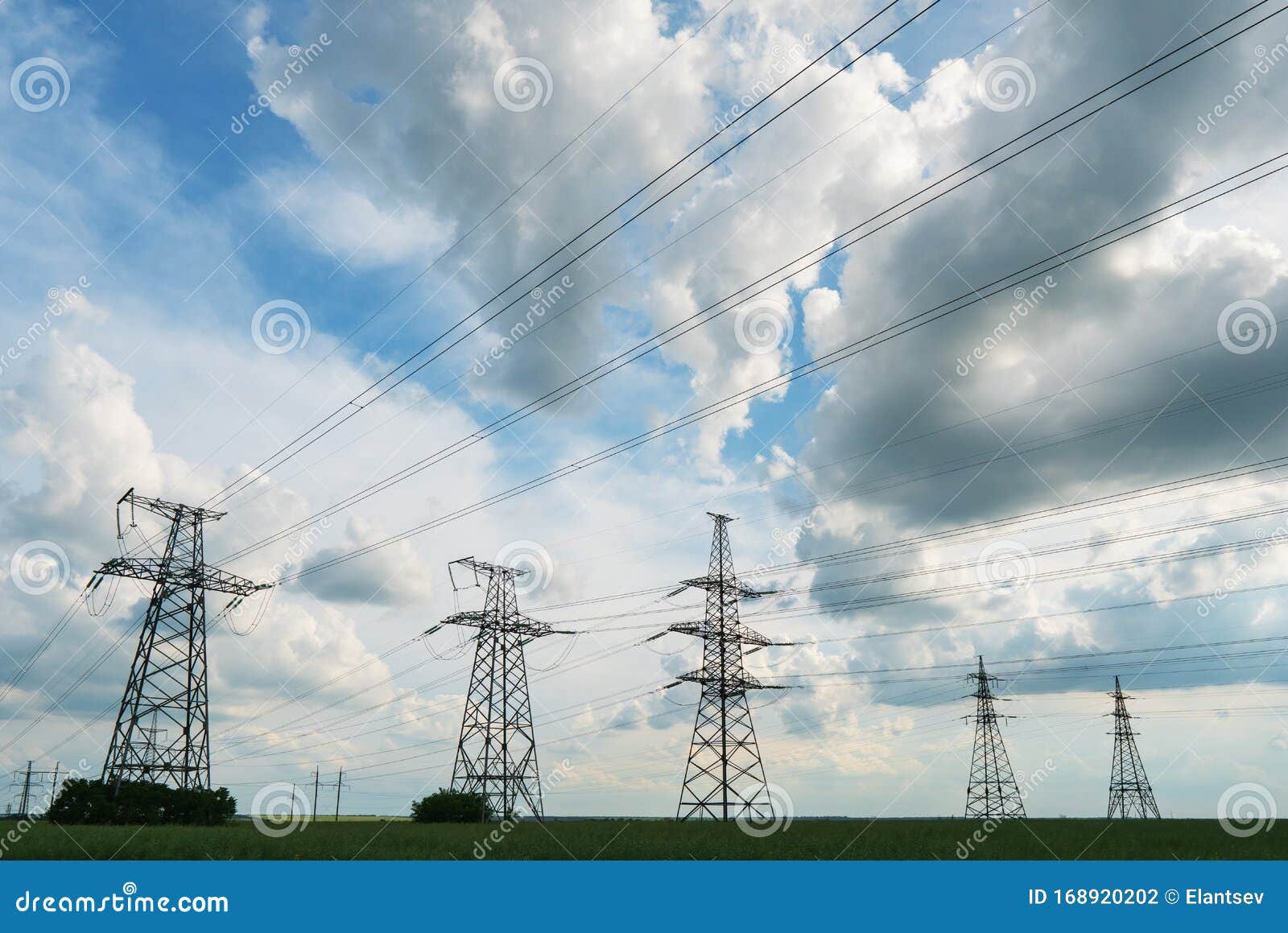 Electrical Net of Poles on a Panorama of Blue Sky and Green Meadow ...