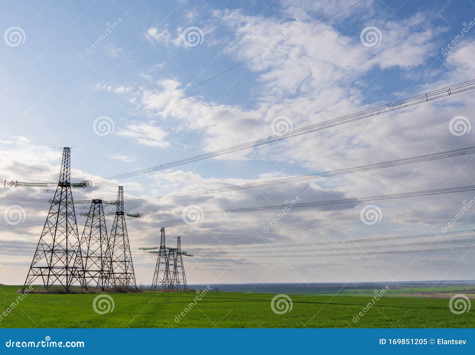 Electrical Net of Poles on a Panorama of Blue Sky and Green Meadow ...