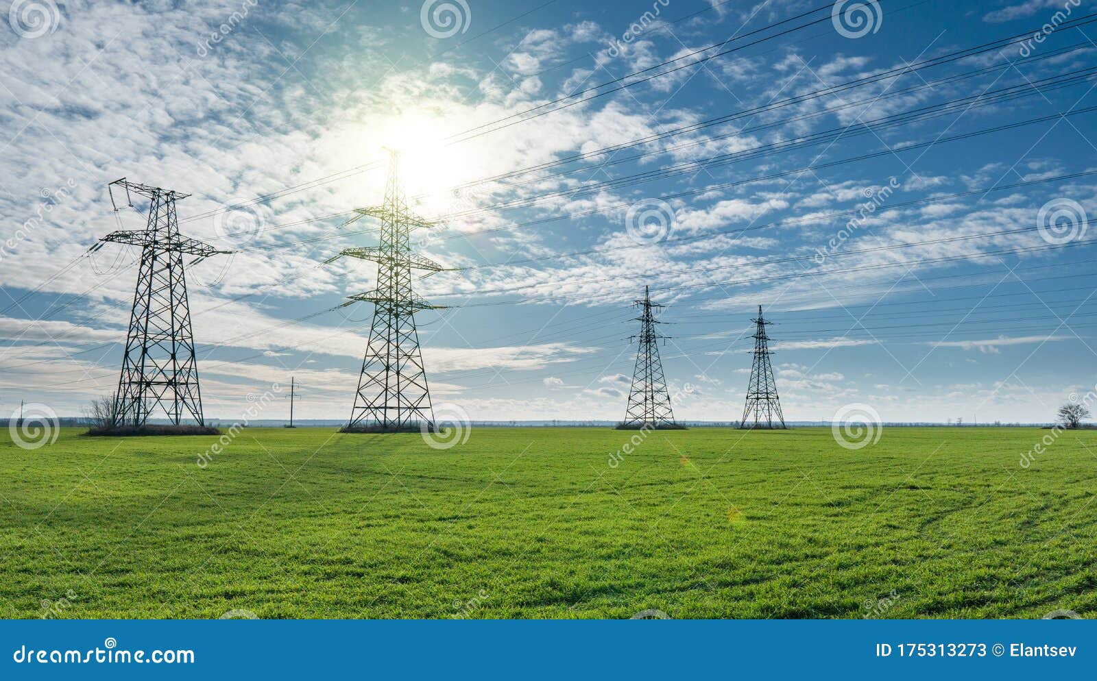 Electrical Net of Poles on a Panorama of Blue Sky and Green Meadow ...