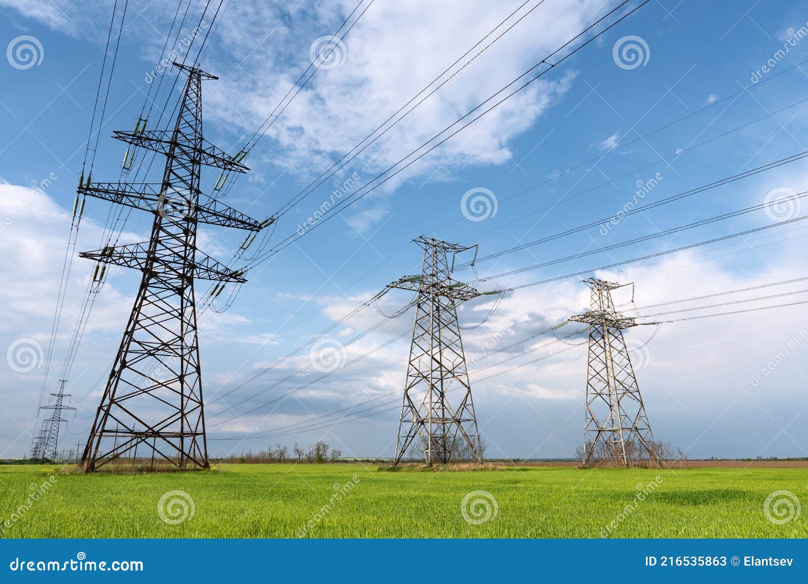 Electrical Net of Poles on a Panorama of Blue Sky and Green Meadow ...