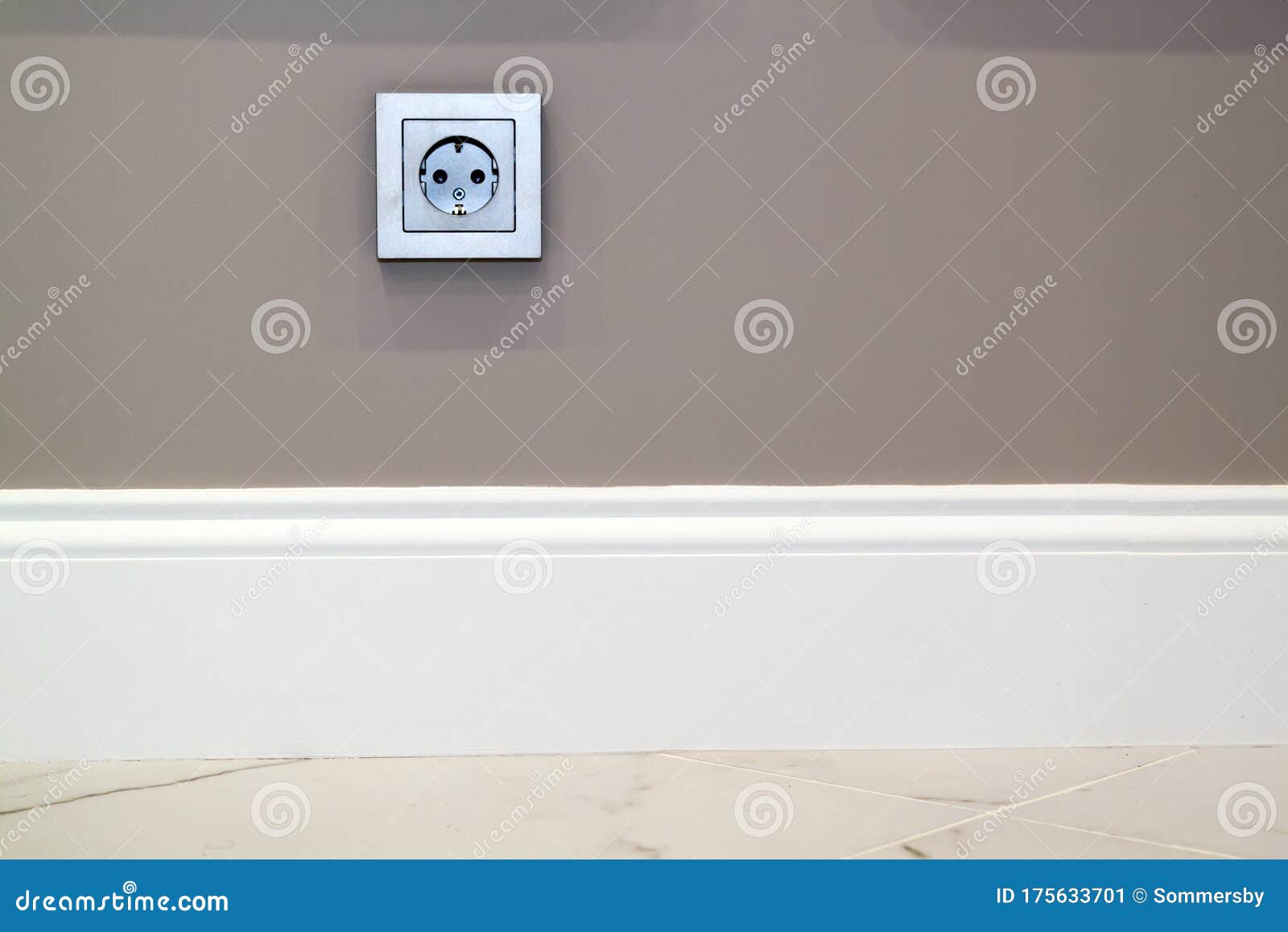 Electrical Outlet on the Brown Wall Above the Baseboard and Marble ...