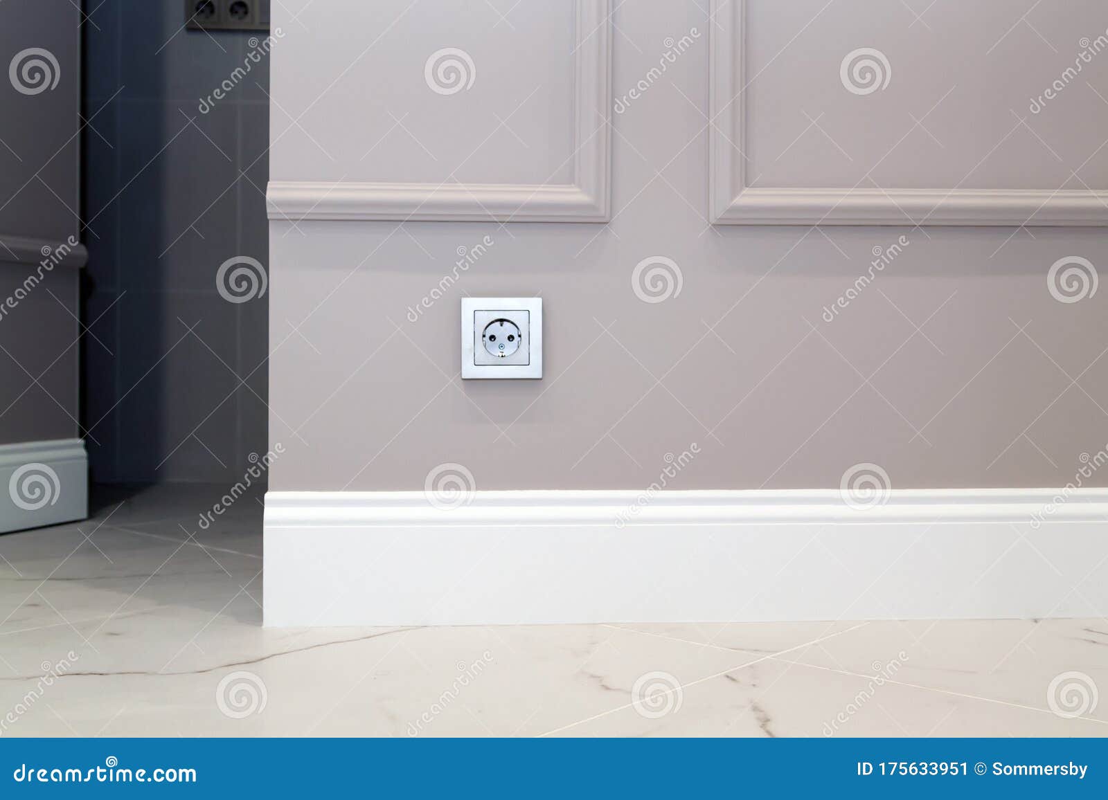 Electrical Outlet on the Brown Wall Above the Baseboard and Marble ...