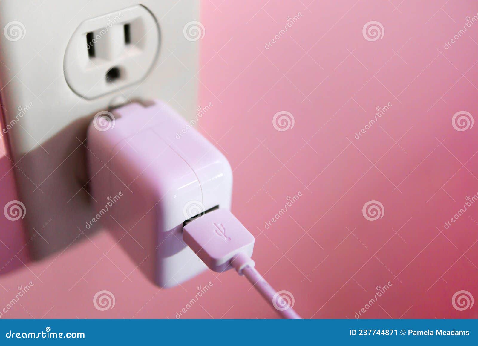 An Electrical Plug on a Pink Wall with a Tablet USB Plug Stock Image ...