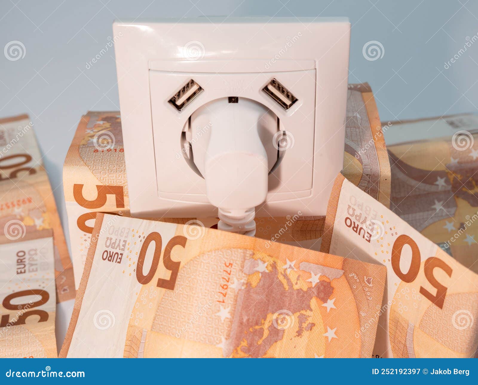 An Electrical Socket with a Connected Plug and Euro Banknotes Around it ...