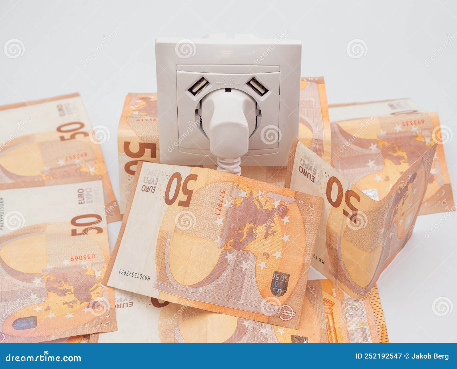 An Electrical Socket with a Connected Plug and Euro Banknotes Around it ...