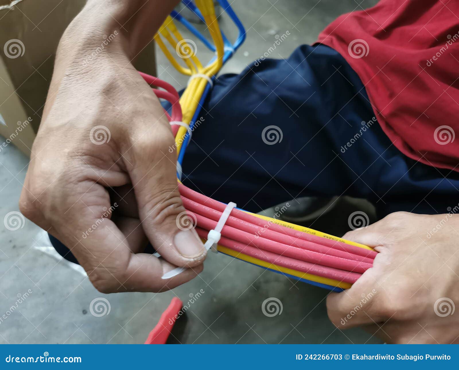 An Electrical Technician Apply Zip Ties To a Bundle of Wires. Stock ...