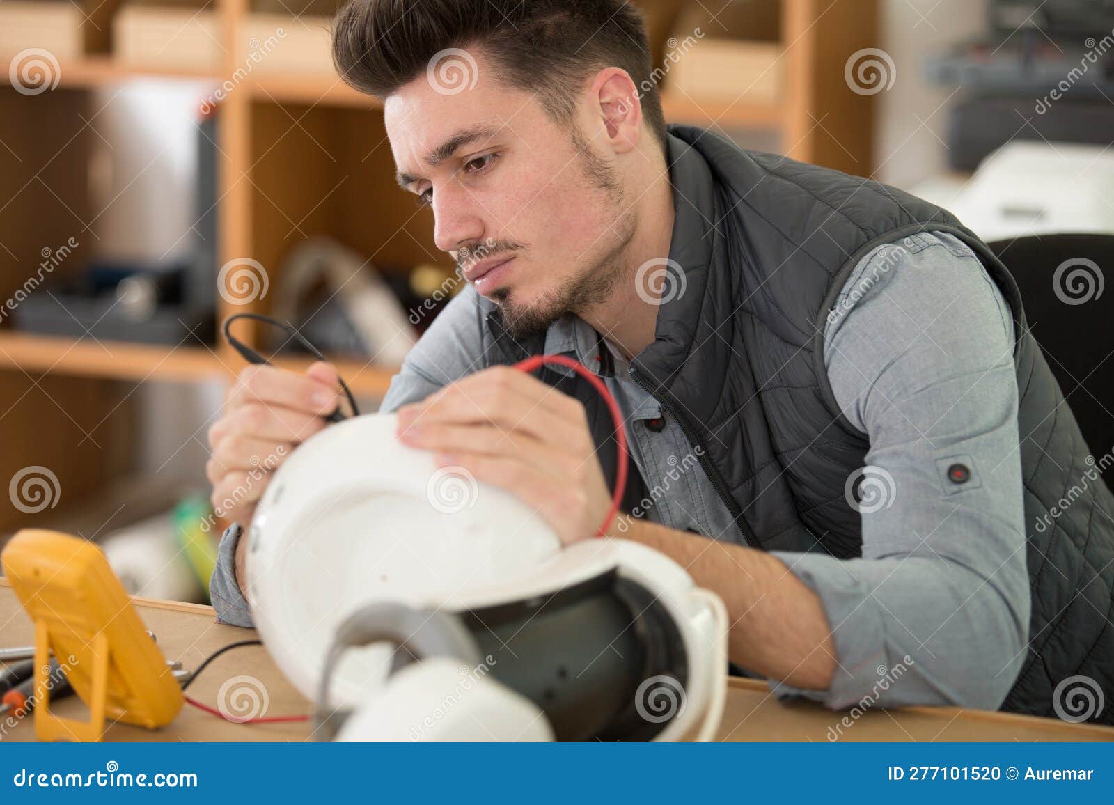 Electrical Technician Fixing Something in Workshop Stock Photo - Image ...