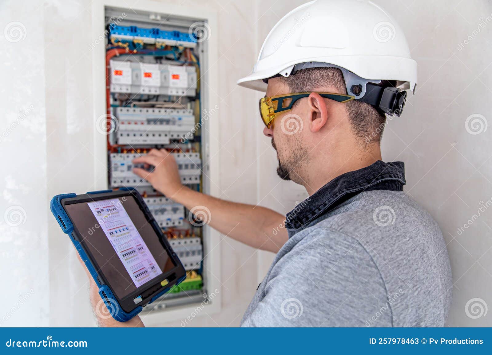 Electrical Technician Looking Focused while Working in a Switchboard ...