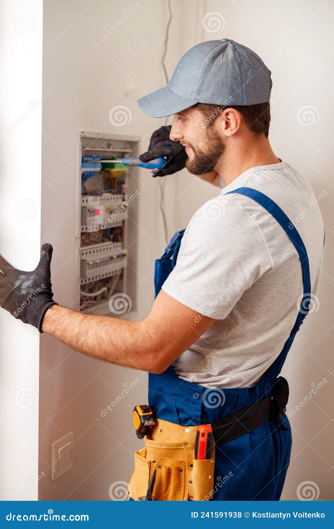 Electrical Technician in Uniform Looking Focused while Checking Fuses ...