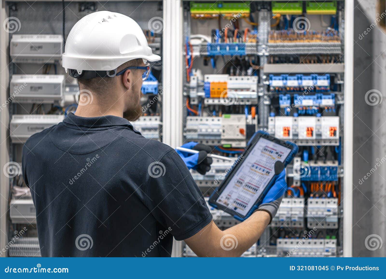 Electrician with Tablet Adjusting Circuitry at Junction Box. Stock ...