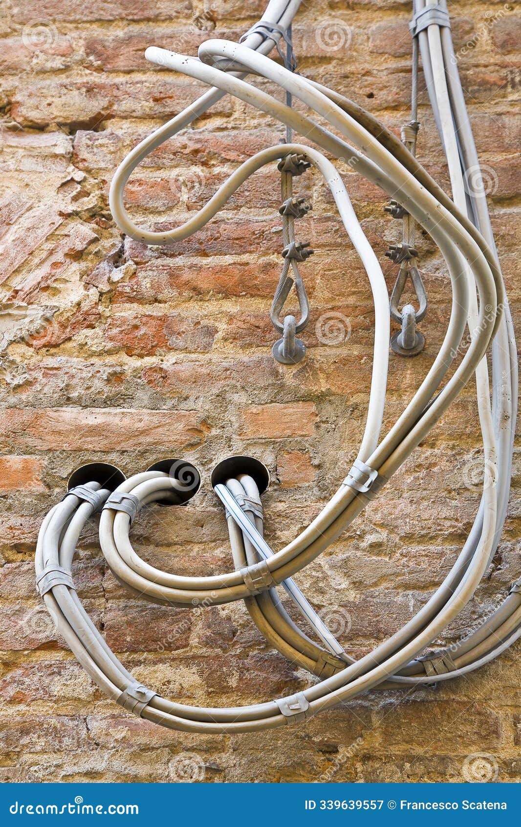 ELECTRICAL and TELEPHONE CABLES Mounted Externally on a Building Wall ...