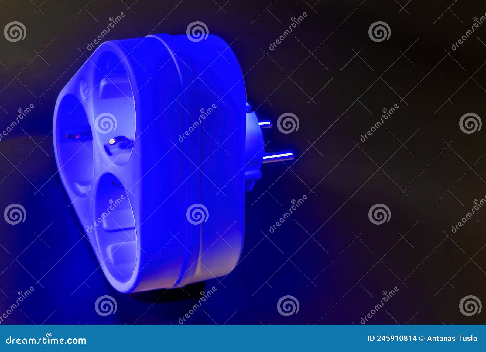 Three-prong Socket Adapter with Grounding on a Dark Background Stock ...