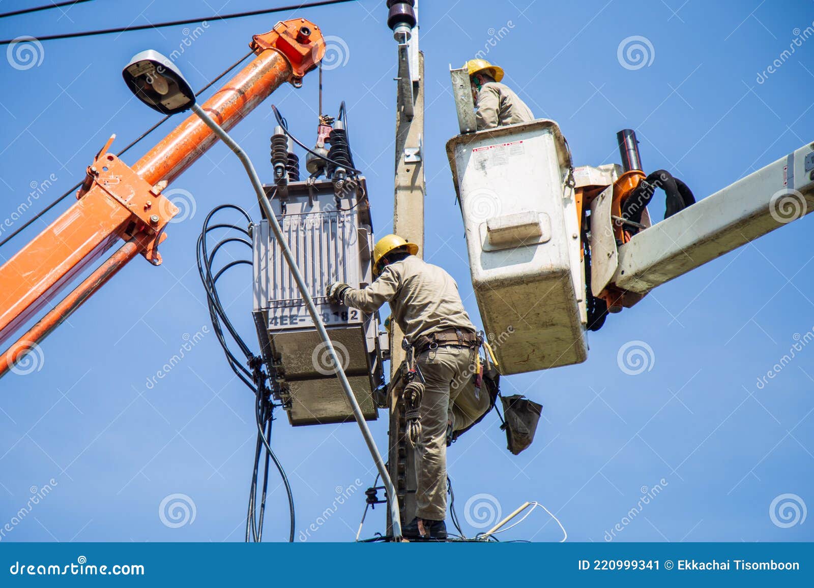 Electrical Wireman are Installing the Transformer To a Light Pole ...