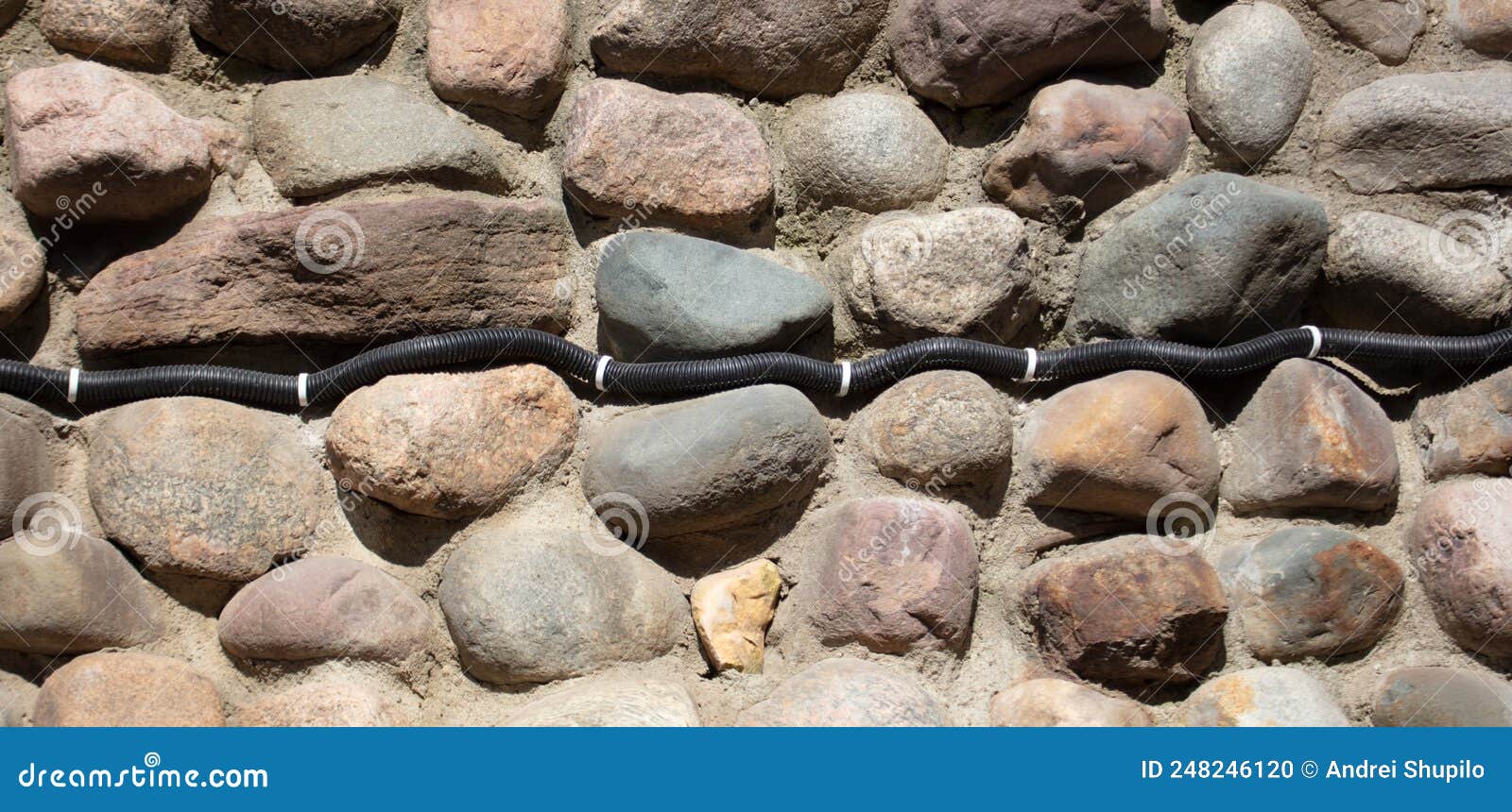 Electrical Wiring on the Wall of Stone Bricks. Stock Photo - Image of ...
