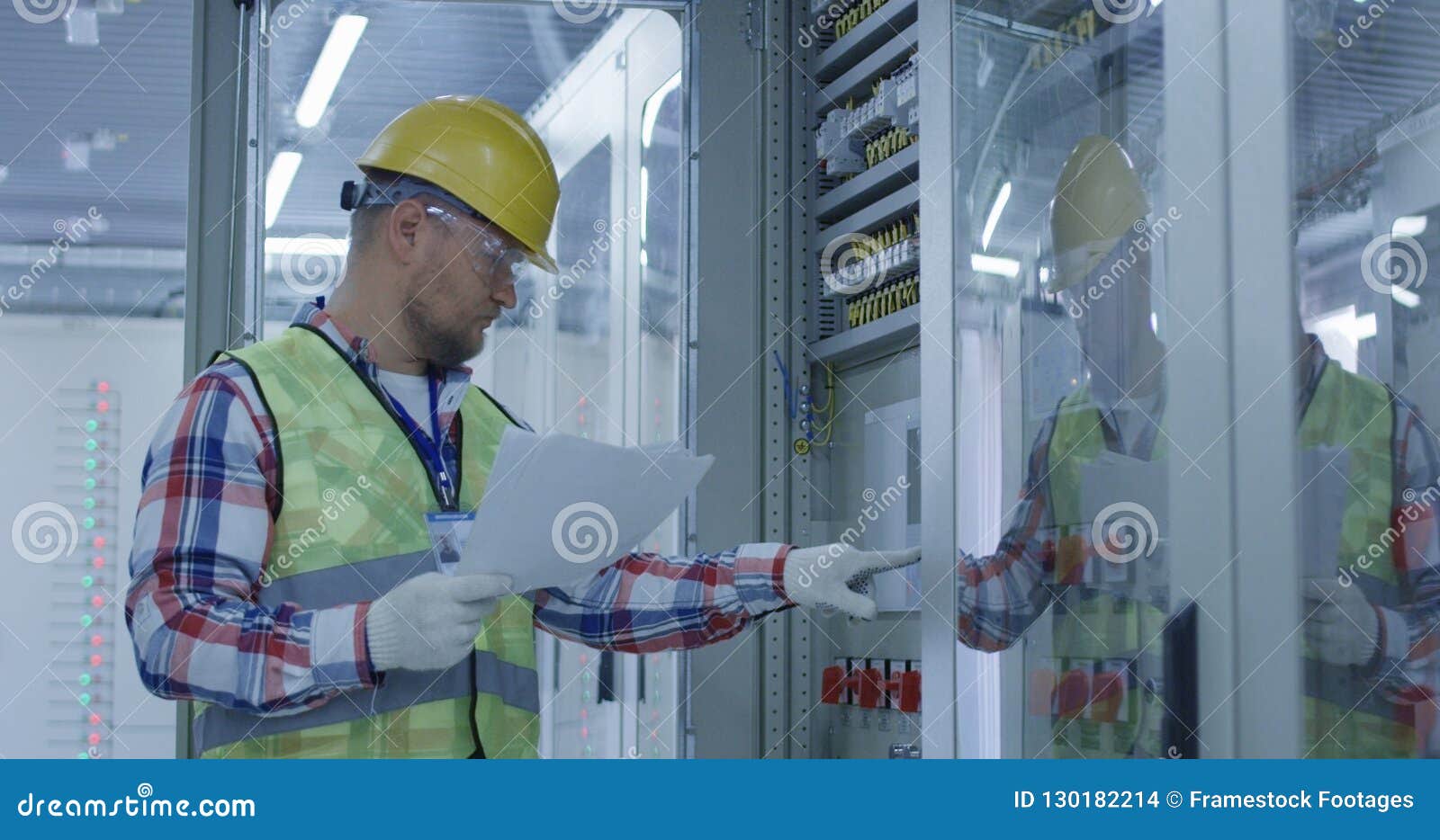 Electrical Worker Reading Paperwork and Inspecting Equipment Stock ...