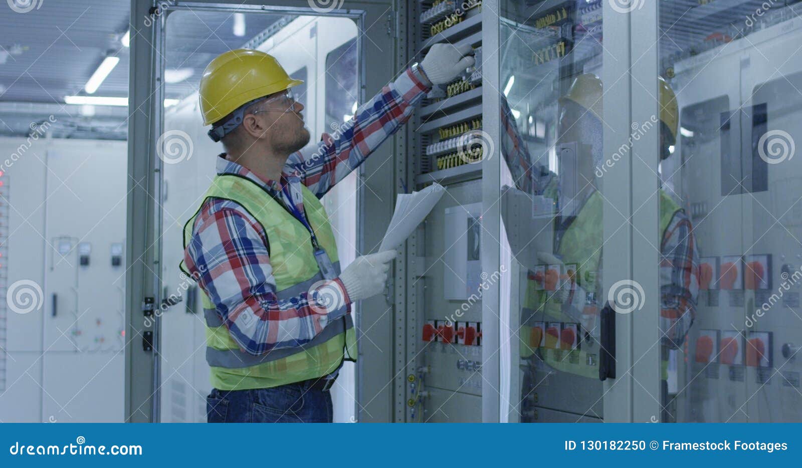 Electrical Worker Reading Paperwork and Inspecting Equipment Stock ...